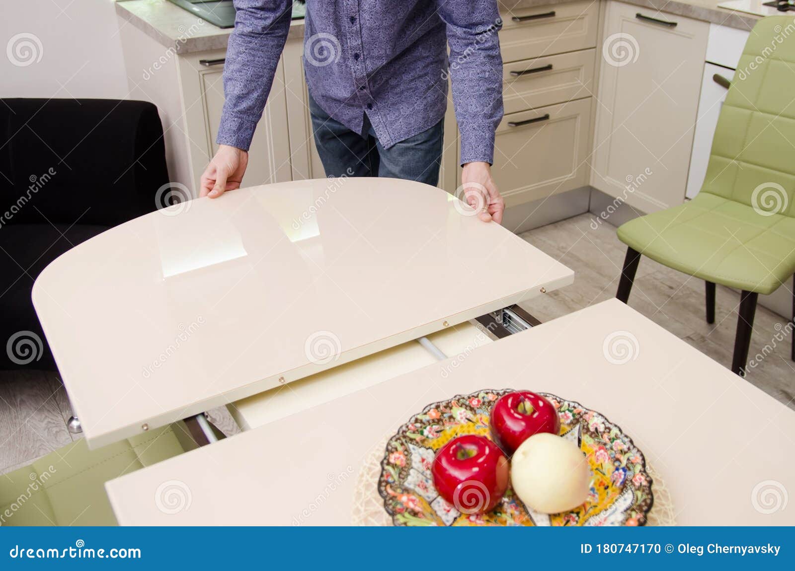 Man Spreads a Sliding Glossy Dining Table on Which Stands a Plate with ...