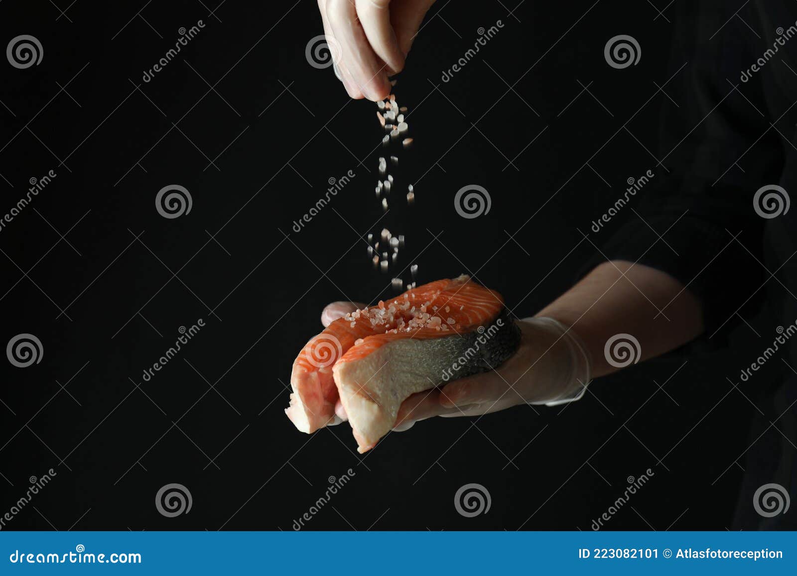Man Sprinkle Salt on Salmon Meat on Dark Background Stock Image - Image ...