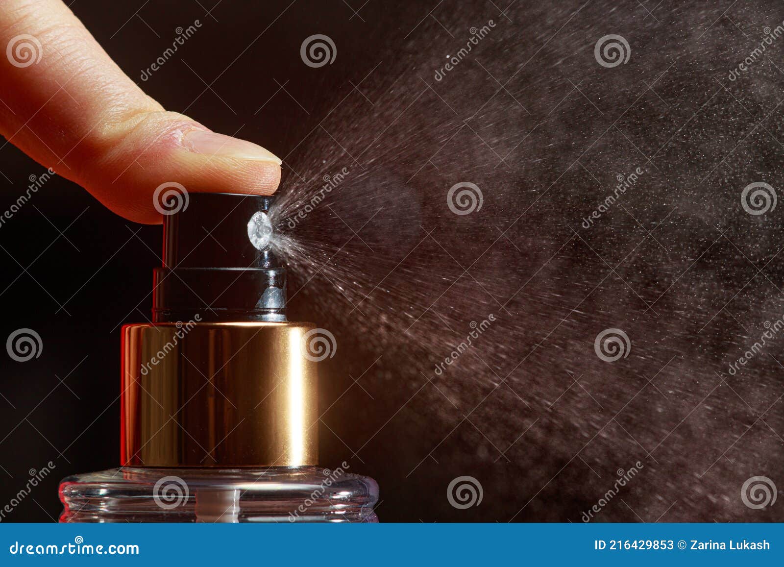 A Man Sprinkles Spray Perfume on a Black Background. Drops and Splashes ...