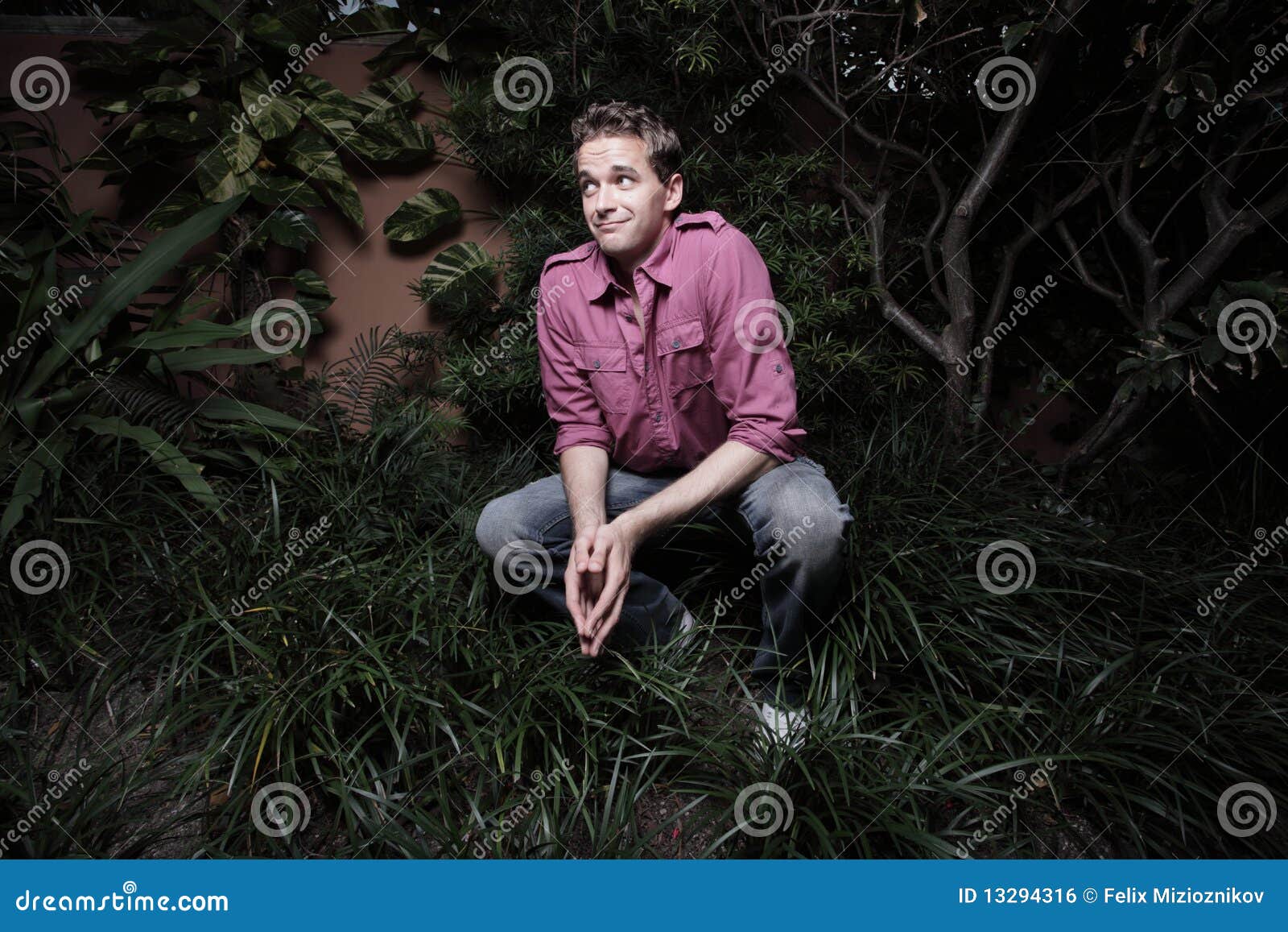Man Squatting in the Bushes Stock Photo - Image of white, dark: 13294316