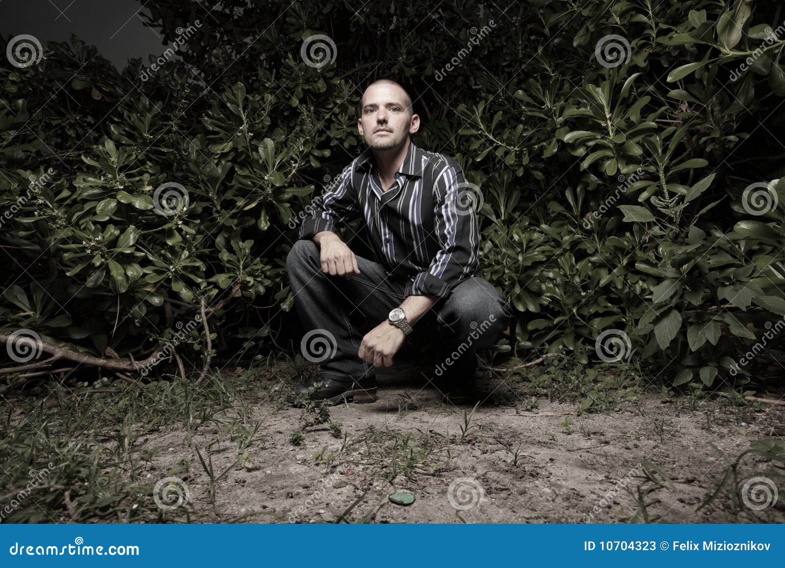 Man Squatting in a Nature Setting Stock Image - Image of angle, squat ...