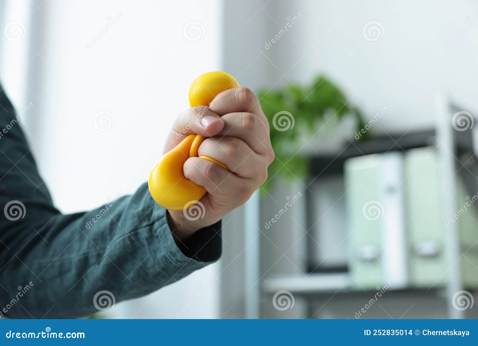Man Squeezing Antistress Ball in Office, Closeup Stock Photo - Image of ...