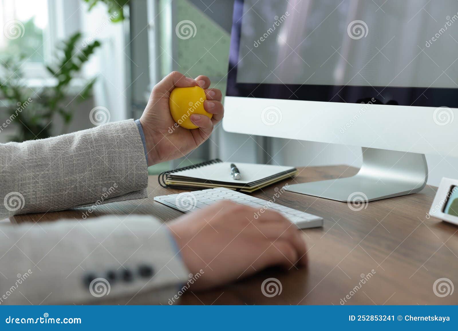 Man Squeezing Antistress Ball while Working with Computer in Office ...