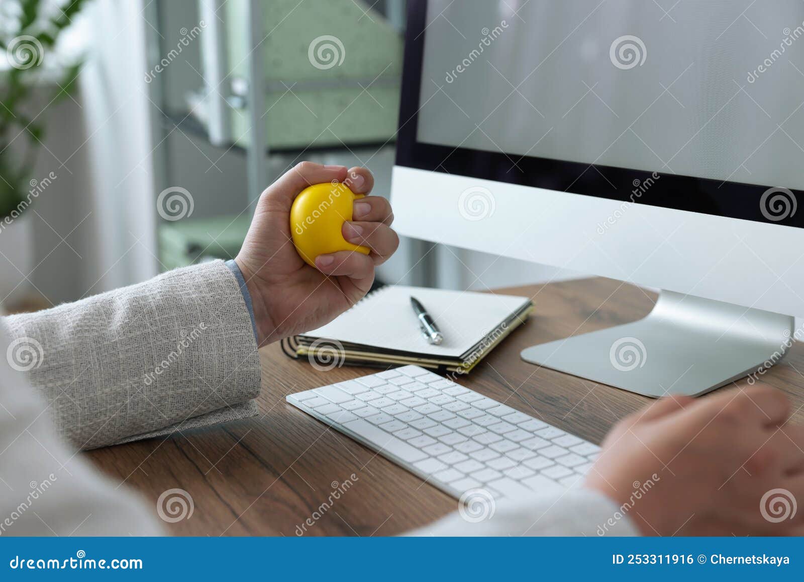 Man Squeezing Antistress Ball while Working with Computer in Office ...