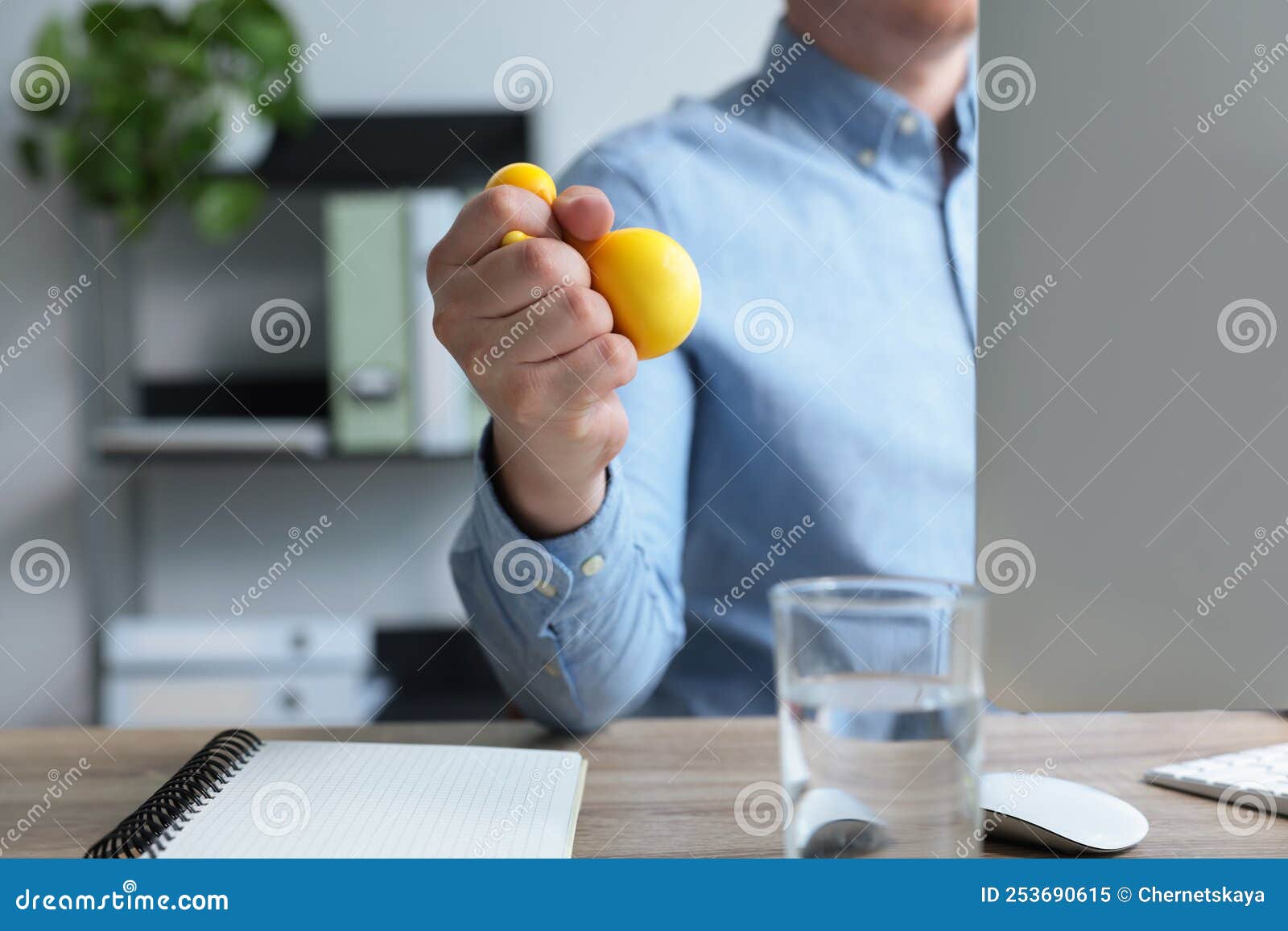 Man Squeezing Antistress Ball while Working with Computer in Office ...