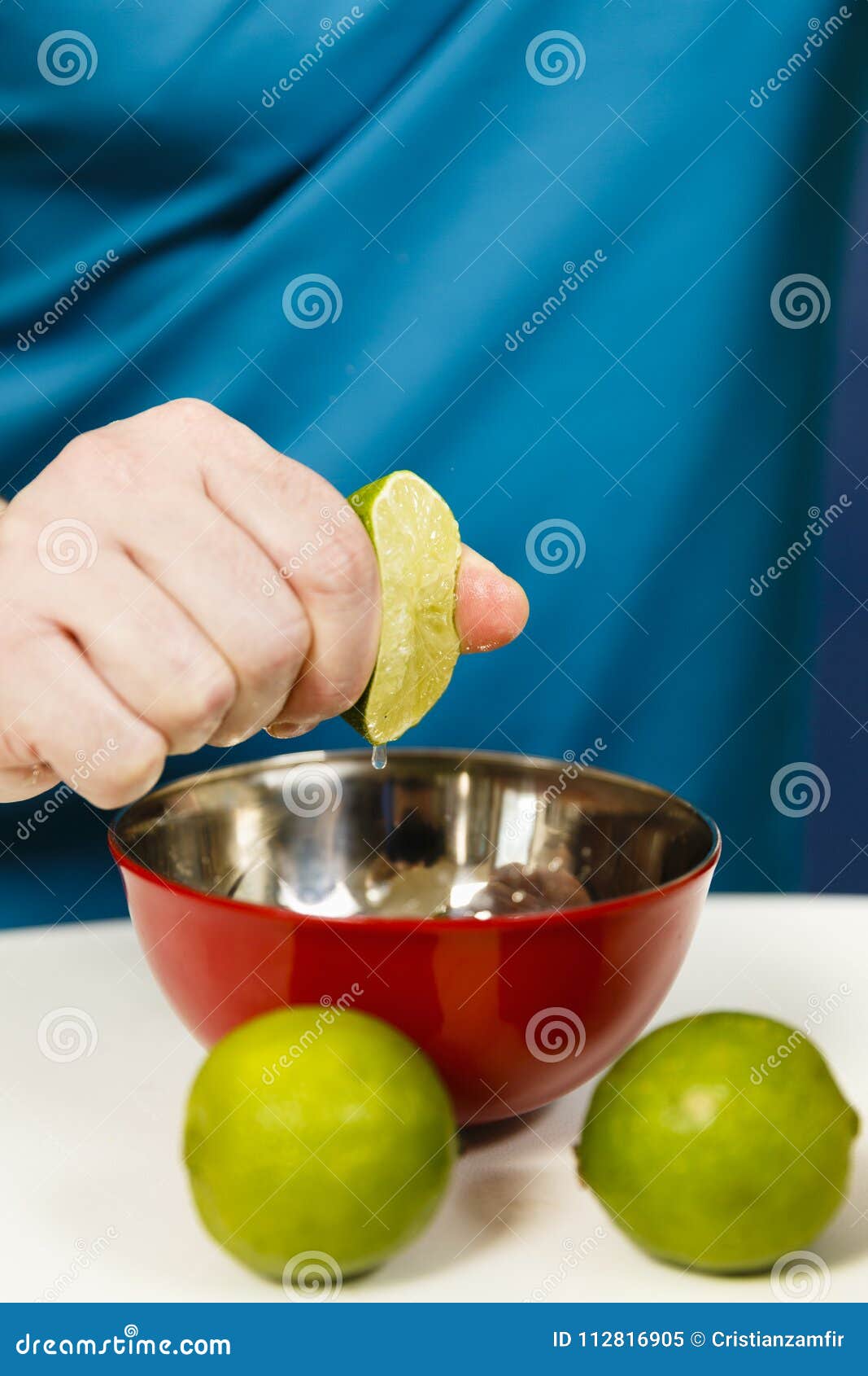 Man Squeezing Half a Lime into a Bowl Stock Image - Image of culinary ...