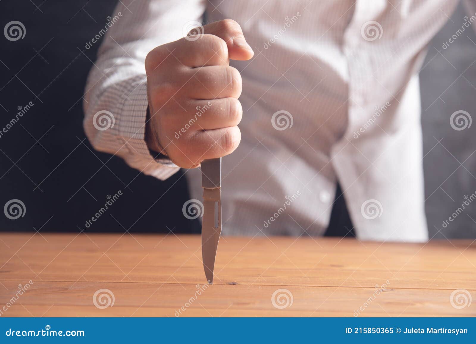 The man stabbed the table stock image. Image of knife - 215850365