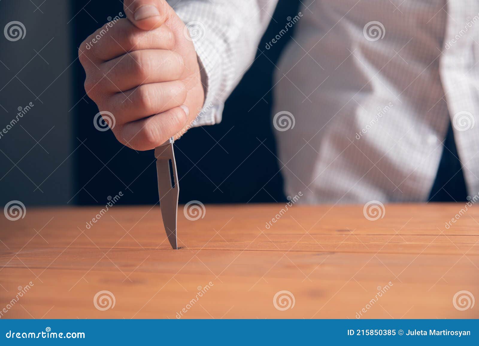 The man stabbed the table stock image. Image of criminal - 215850385