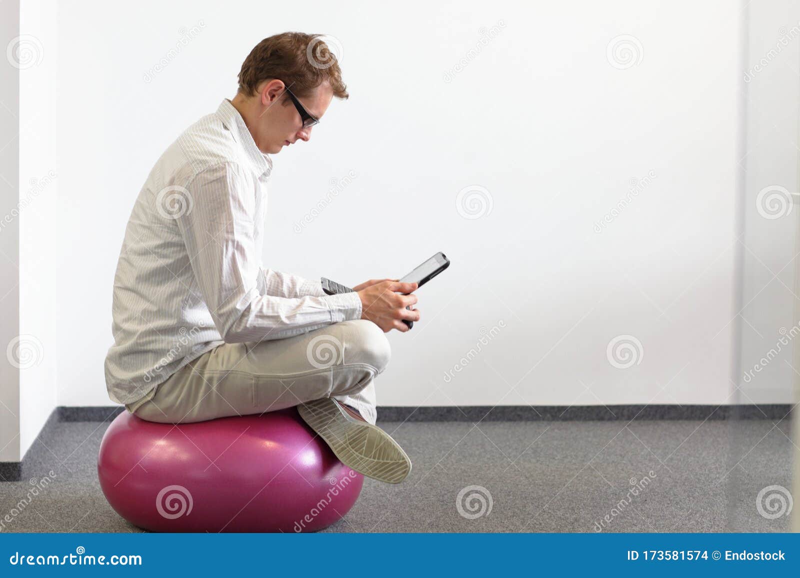 Man on Stability Ball Working with Tablet Stock Photo - Image of ...