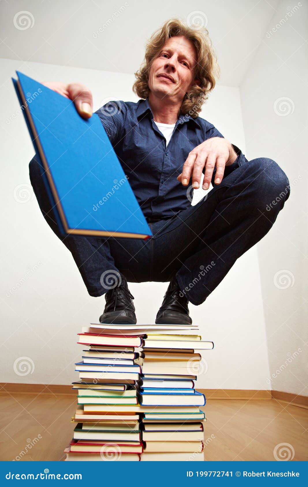 Man on Stack of Books Gives Book Stock Image - Image of pile, research ...