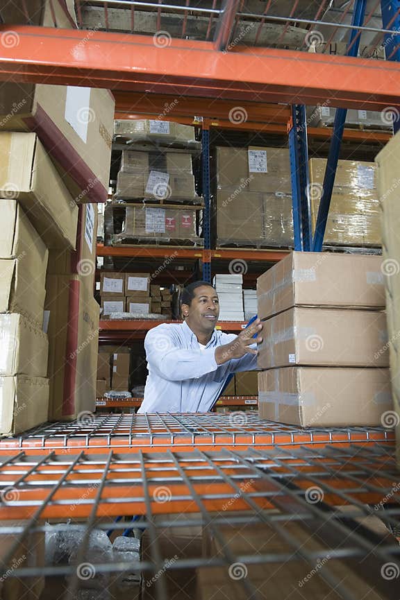 Man Stacking Boxes in Warehouse Stock Image - Image of inspecting ...