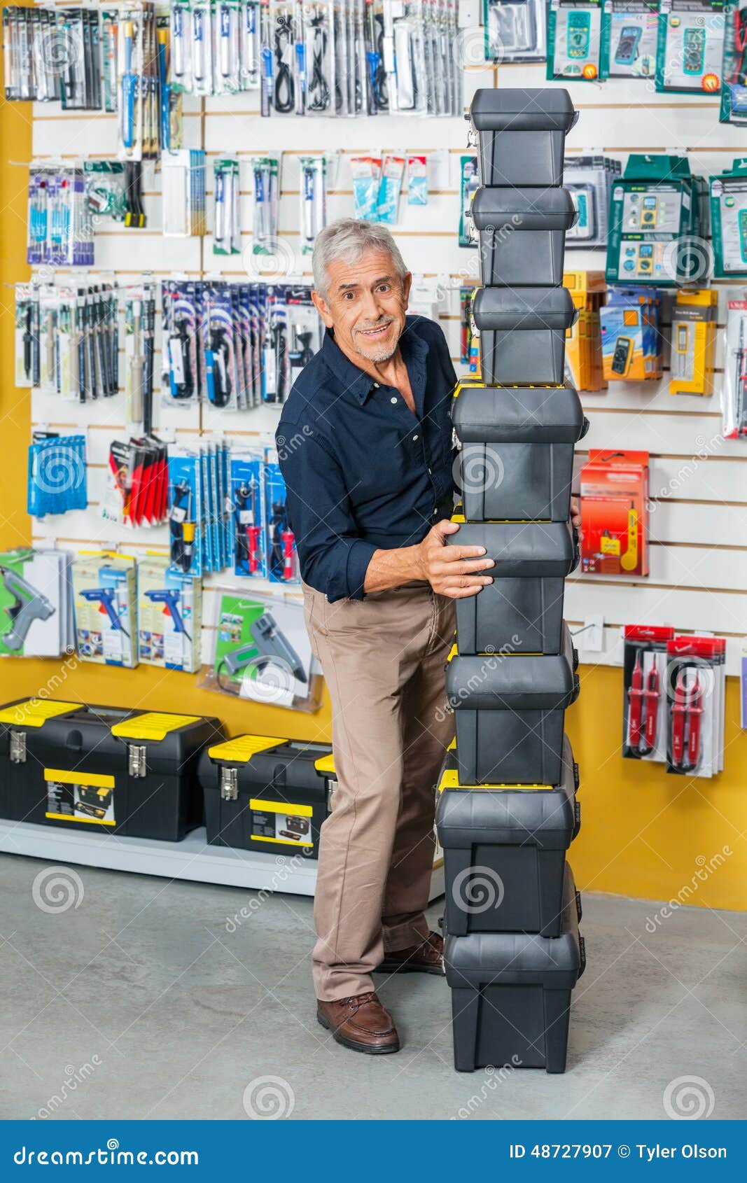 Man Stacking Toolboxes in Hardware Store Stock Image - Image of ...