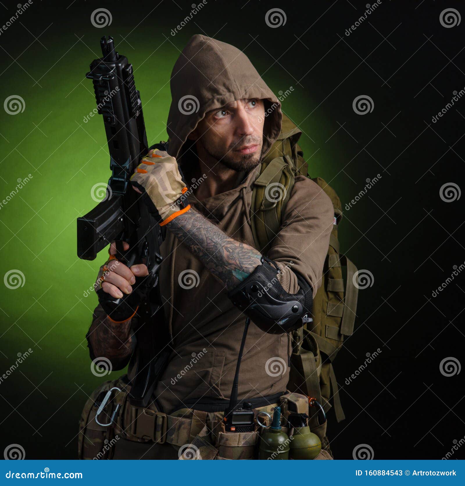 Man Stalker with a Gun with an Optical Sight and a Backpack on a Dark ...