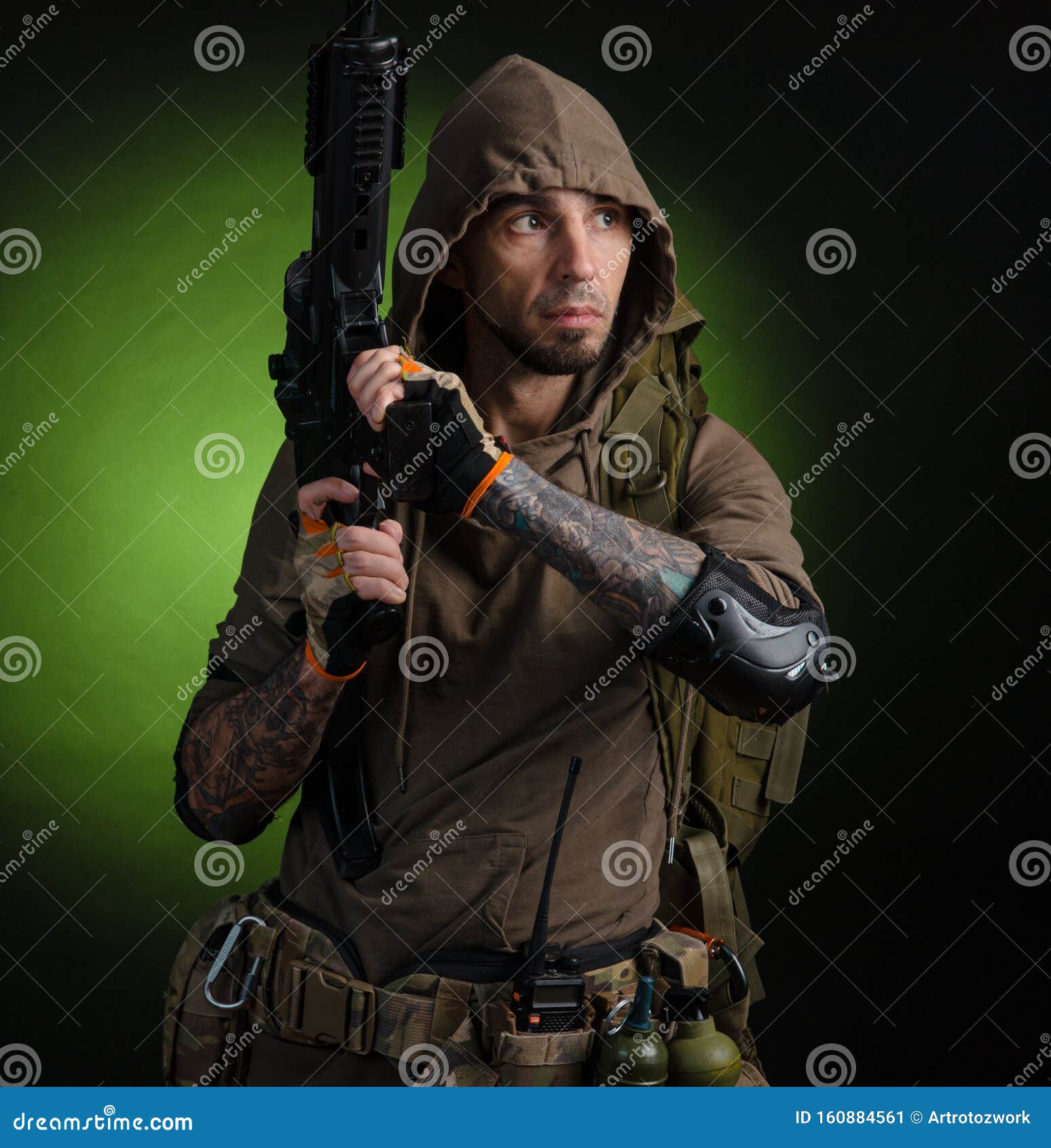 Man Stalker with a Gun with an Optical Sight and a Backpack on a Dark ...