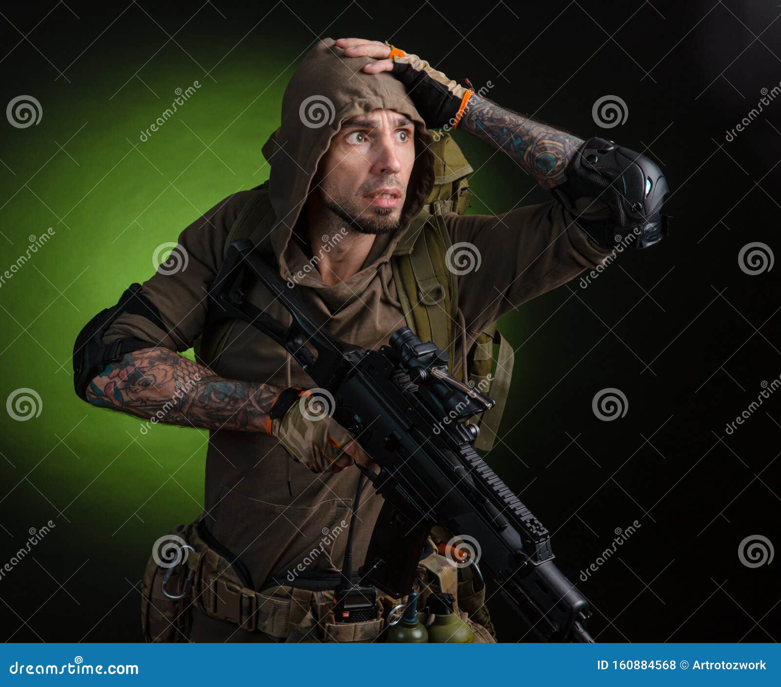 Man Stalker with a Gun with an Optical Sight and a Backpack on a Dark ...