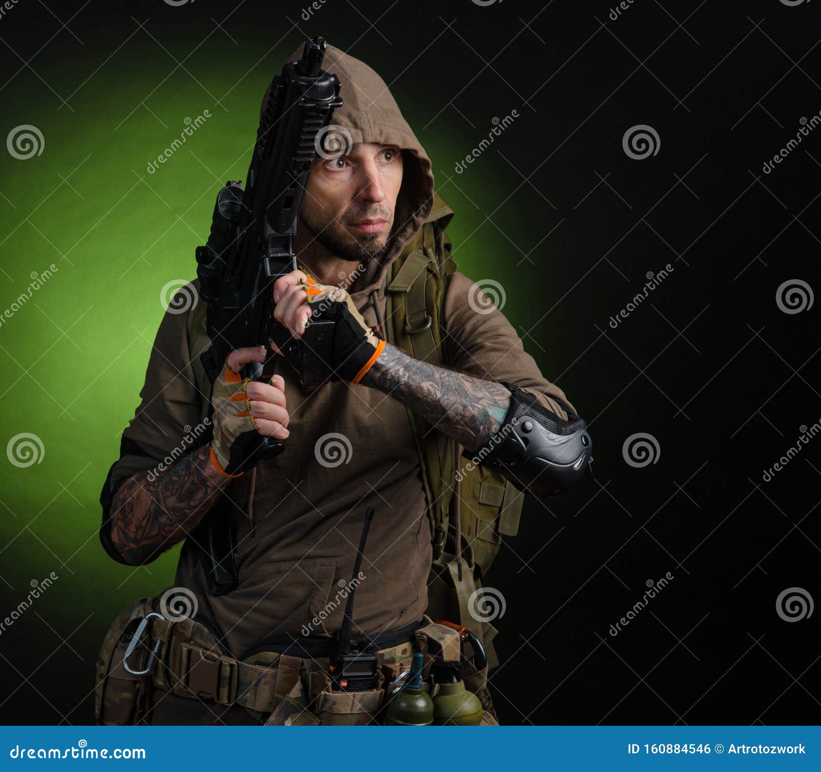 Man Stalker with a Gun with an Optical Sight and a Backpack on a Dark ...