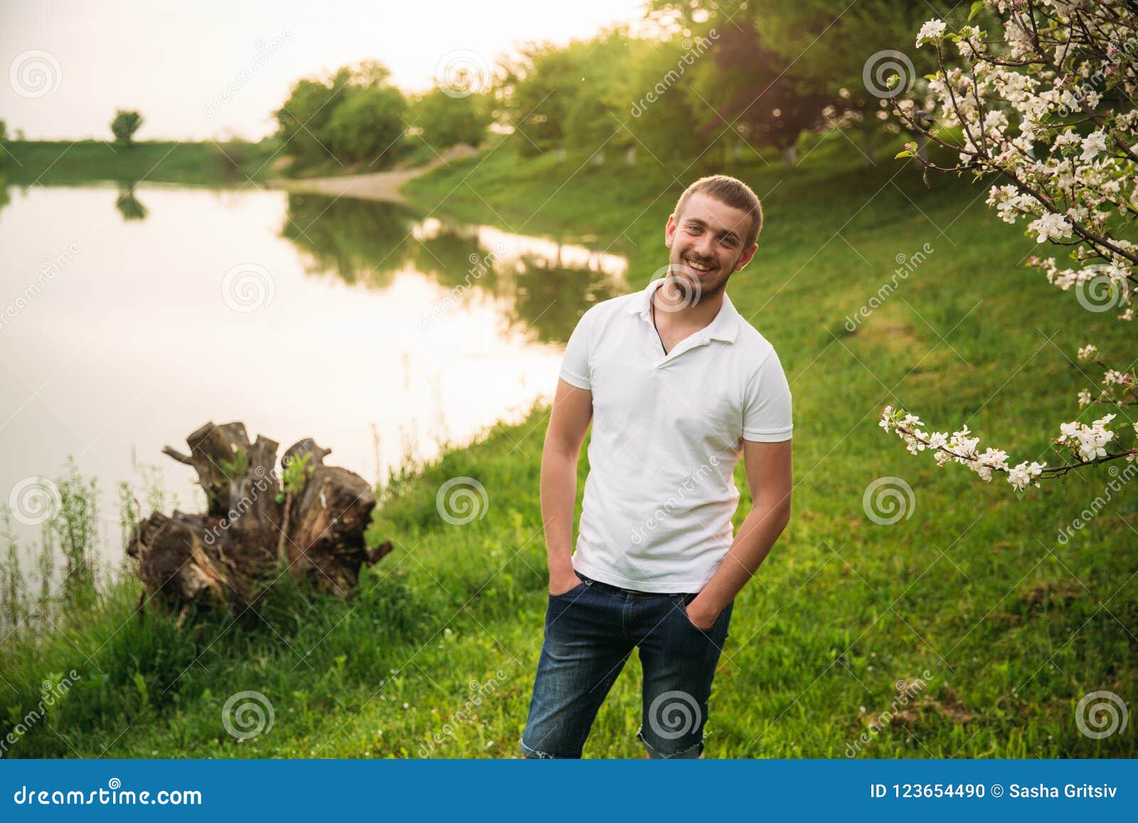 Man Stand on Grass. Background Lake. Spring Time Stock Photo - Image of ...