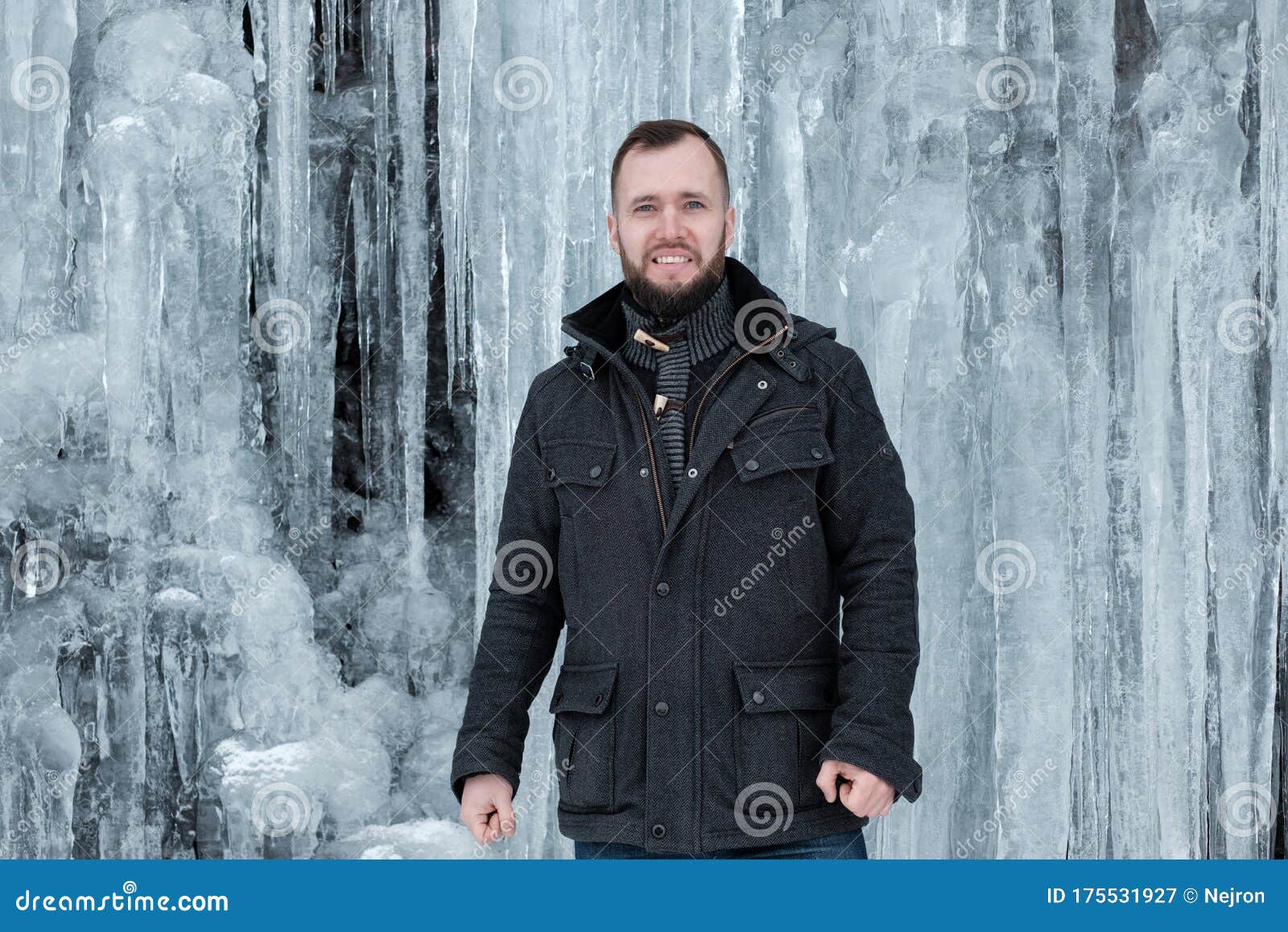 Man Standing Against Cliff Full of Icicles Stock Image - Image of ...