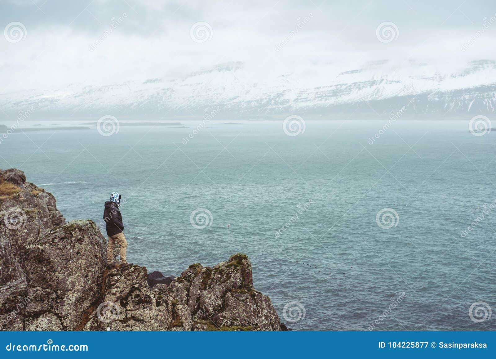 A Man Standing Alone on Cliff in Rainy Day in Iceland Stock Image ...