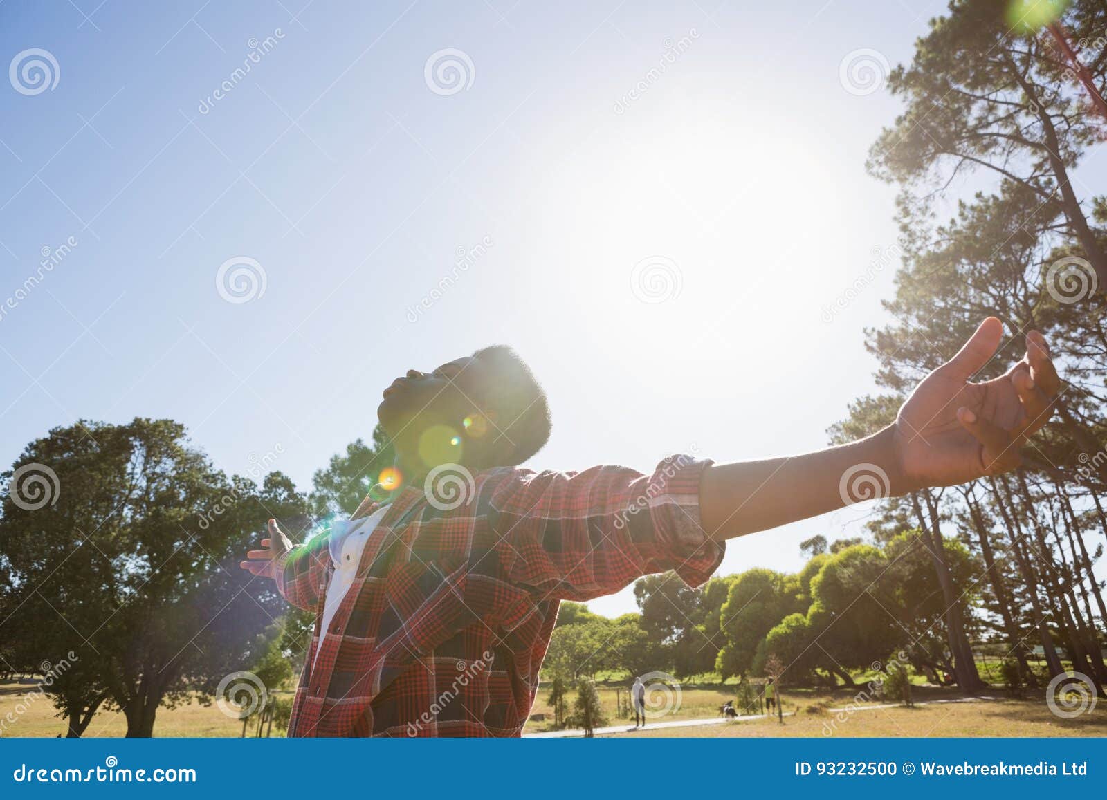 Man Standing with Arms Outstretched in the Park Stock Photo - Image of ...
