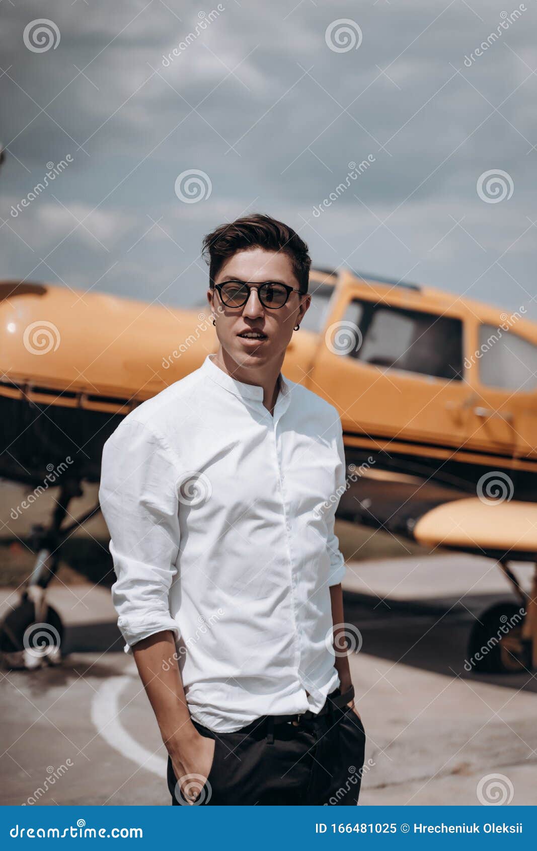 A Man Standing on the Background of a Small Single Engine Plane. Stock ...