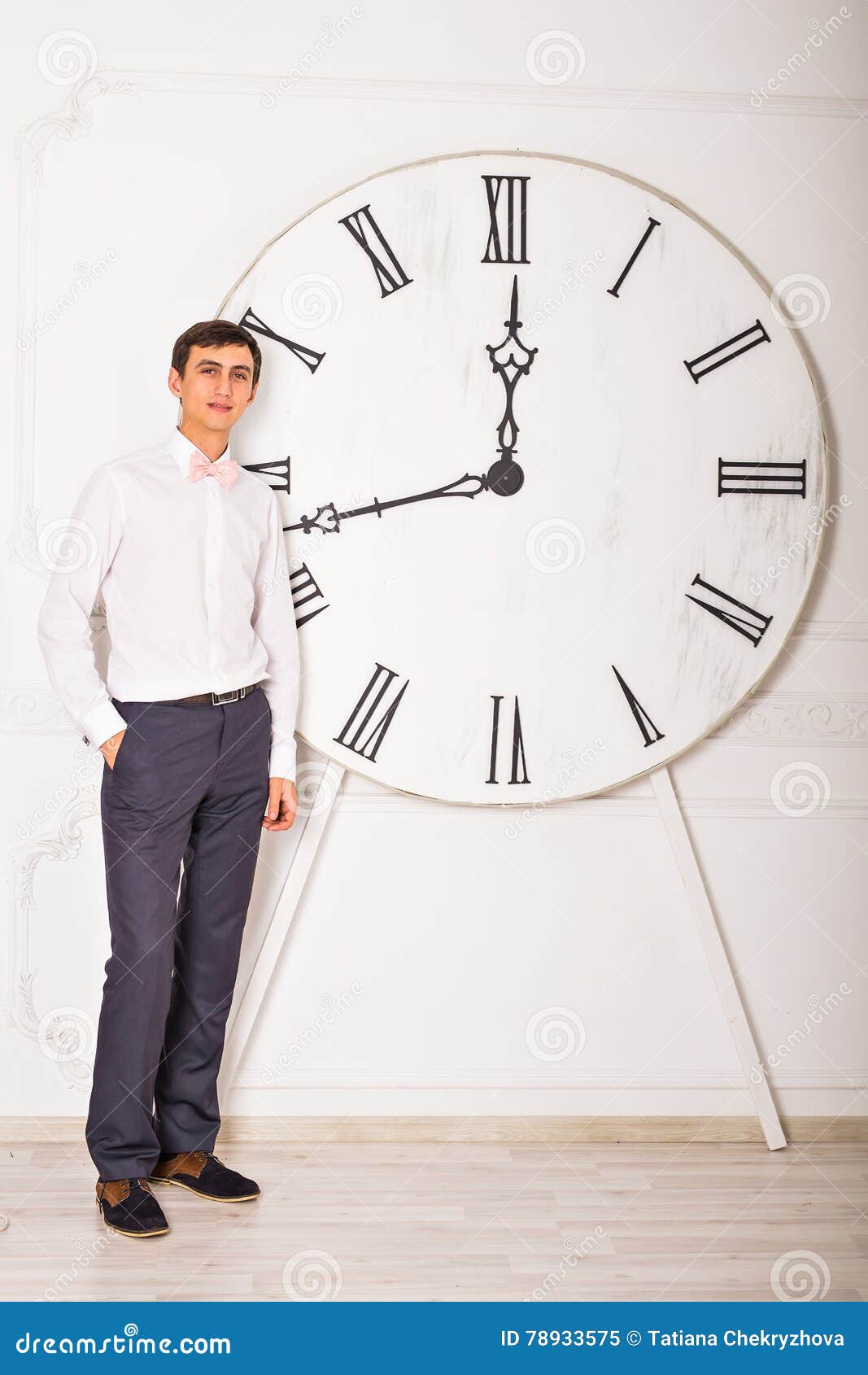 Man Standing beside a Big Clock on White Wall Stock Image - Image of ...