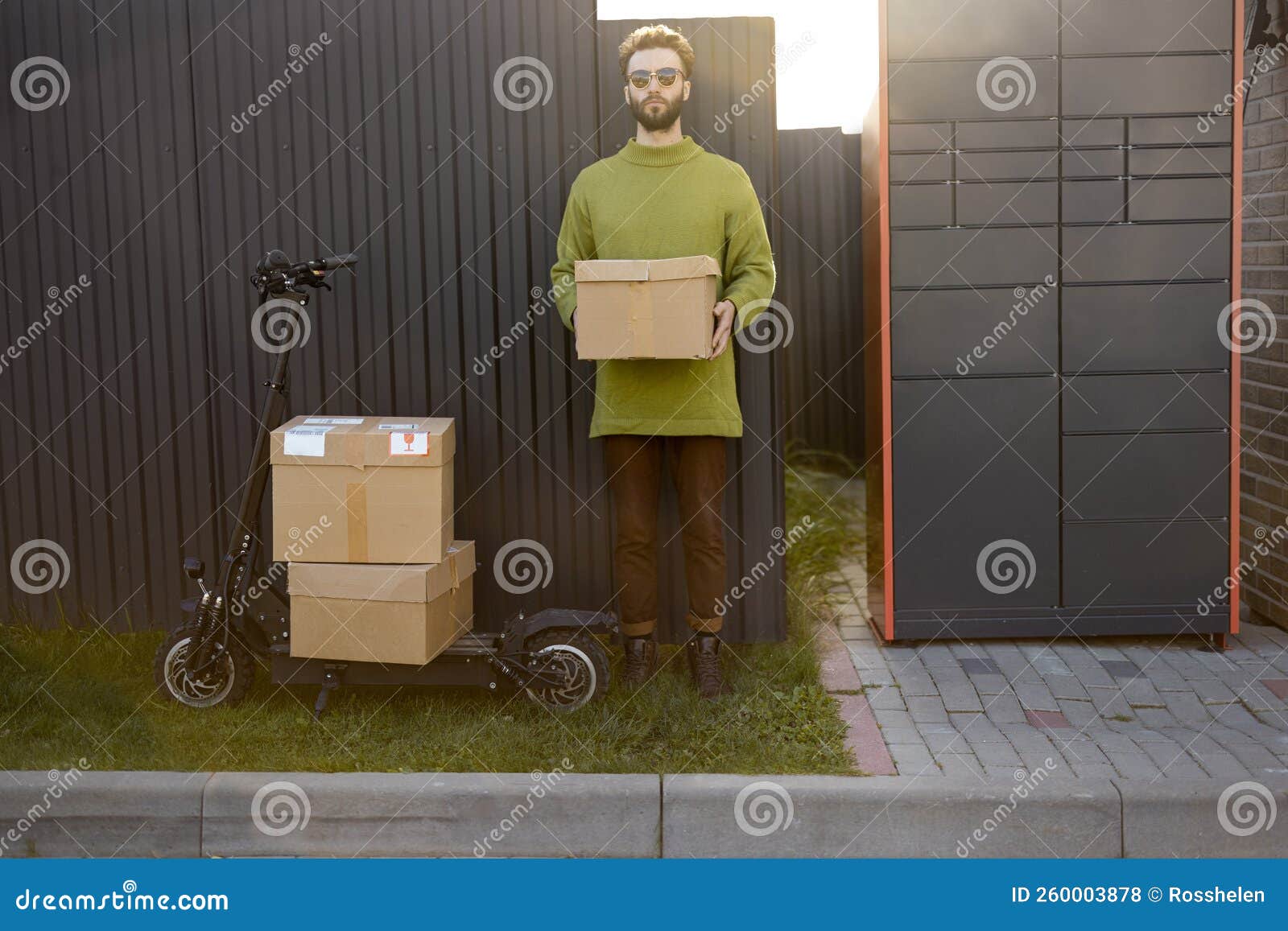 Man Standing with Box Near Automatic Post Terminal and Scooter Stock ...