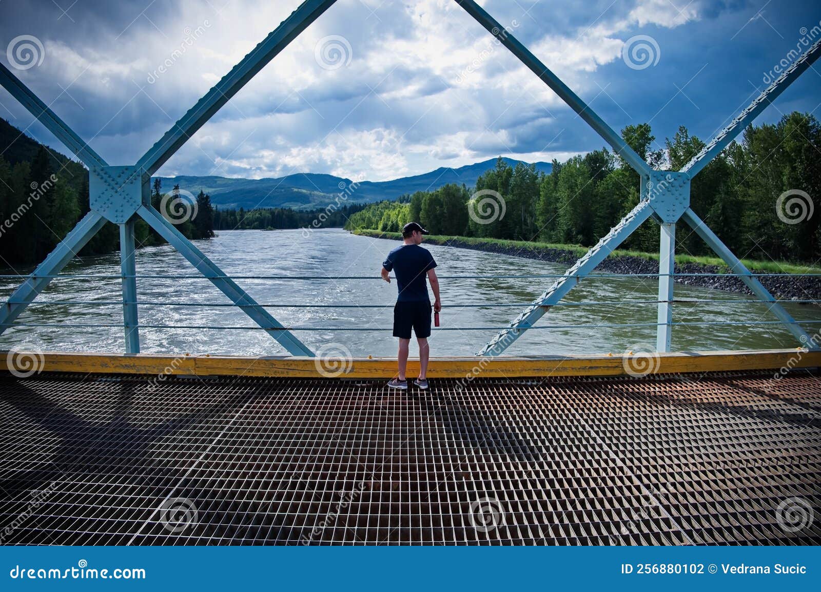 Man standing on the bridge stock photo. Image of nature - 256880102
