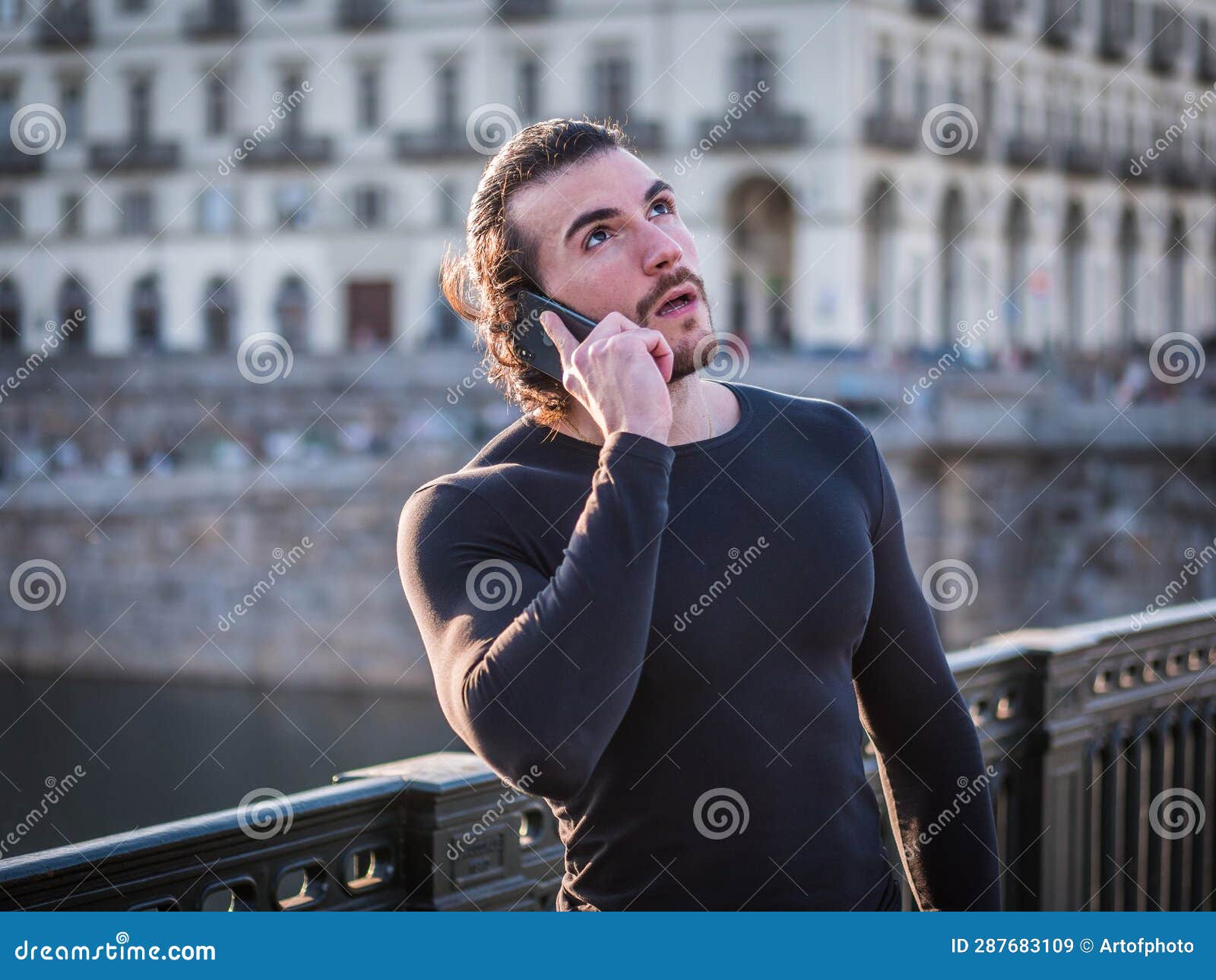 Photo of a Man on a Bridge Talking on a Cell Phone Stock Image - Image ...