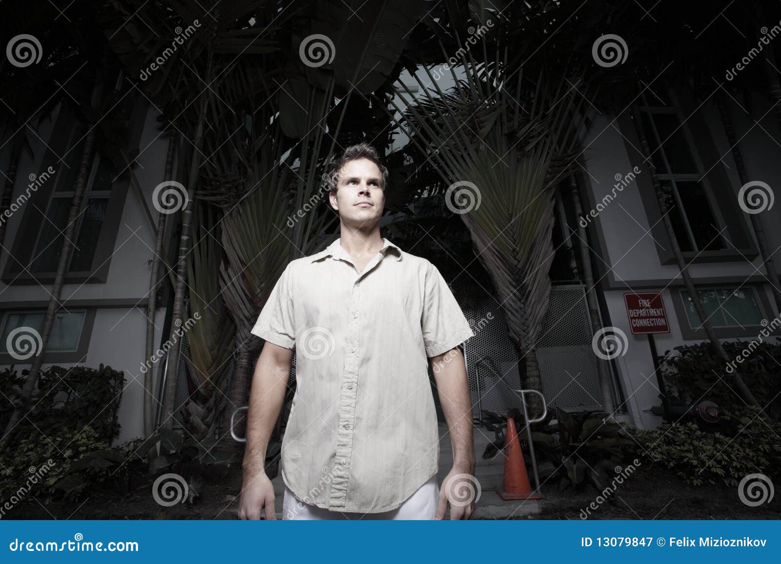 Man Standing with a Building in the Background Stock Image - Image of ...