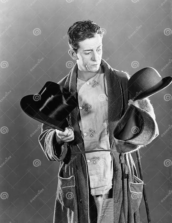 Man Standing and Deciding between Two Hats Stock Photo - Image of ...