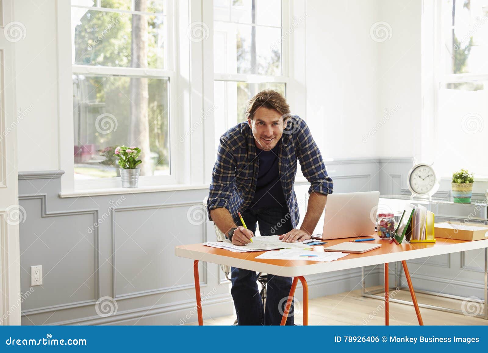 Man Standing at Desk Working at Laptop in Home Office Stock Photo ...