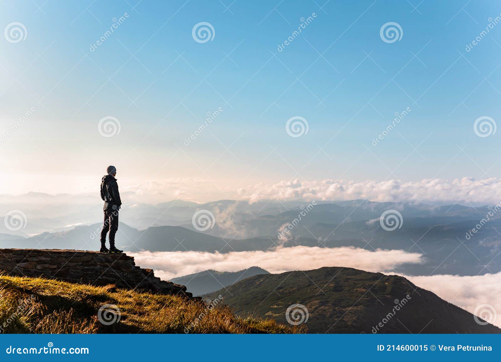Man Standing at the Edge of the Cliff Looking at Mountains Stock Image ...