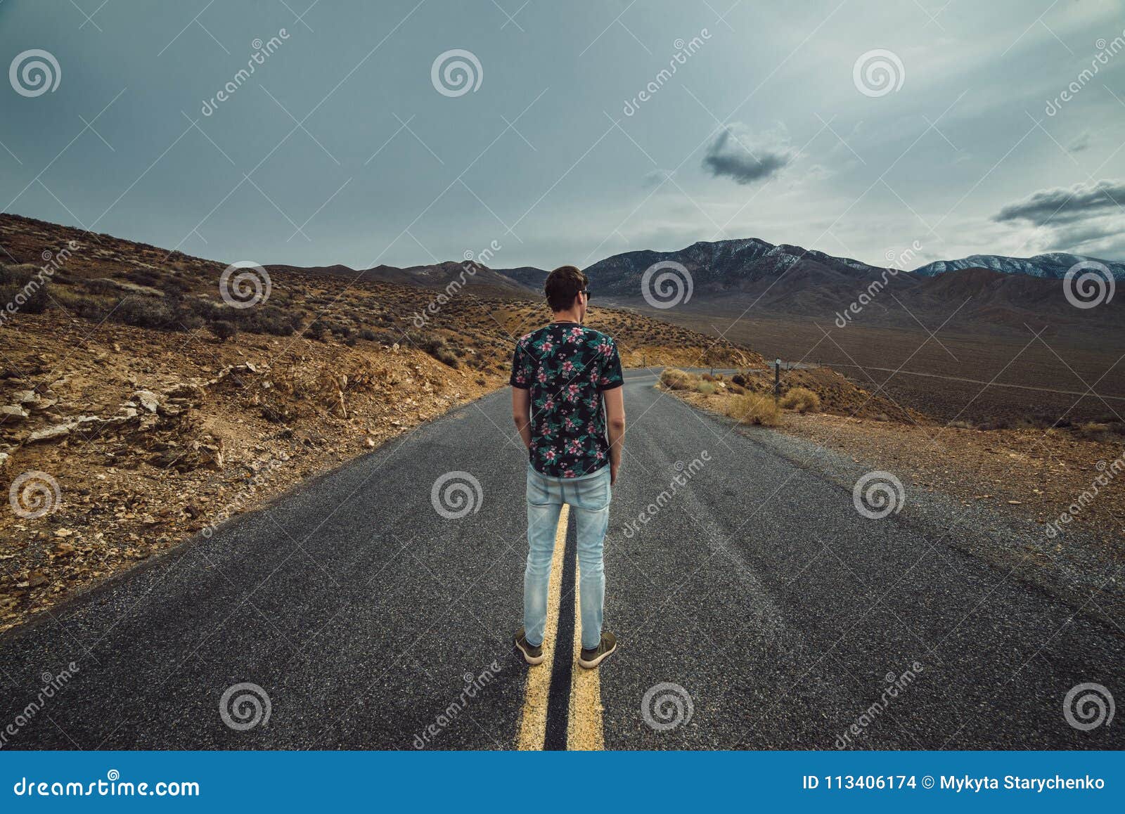 Man Standing on Empty Desert Asphalt Road Waiting and Thinking. View ...