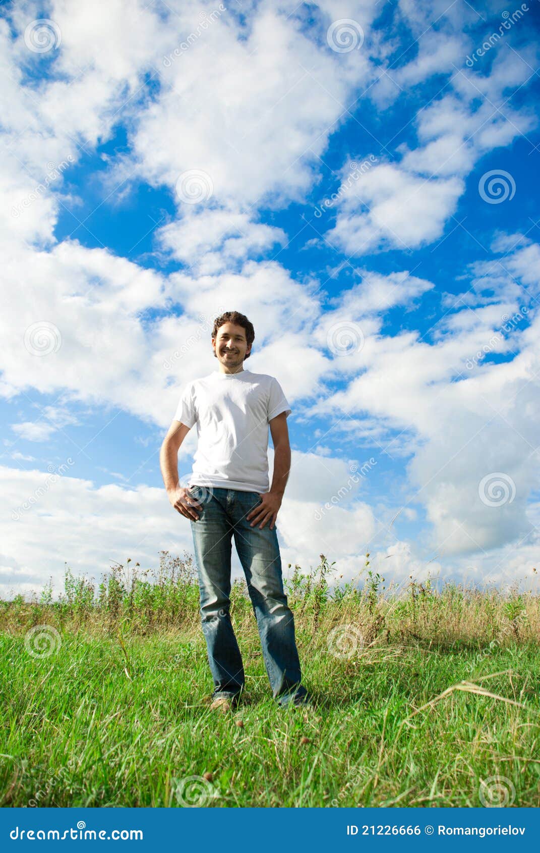 Man standing in a field stock photo. Image of person - 21226666