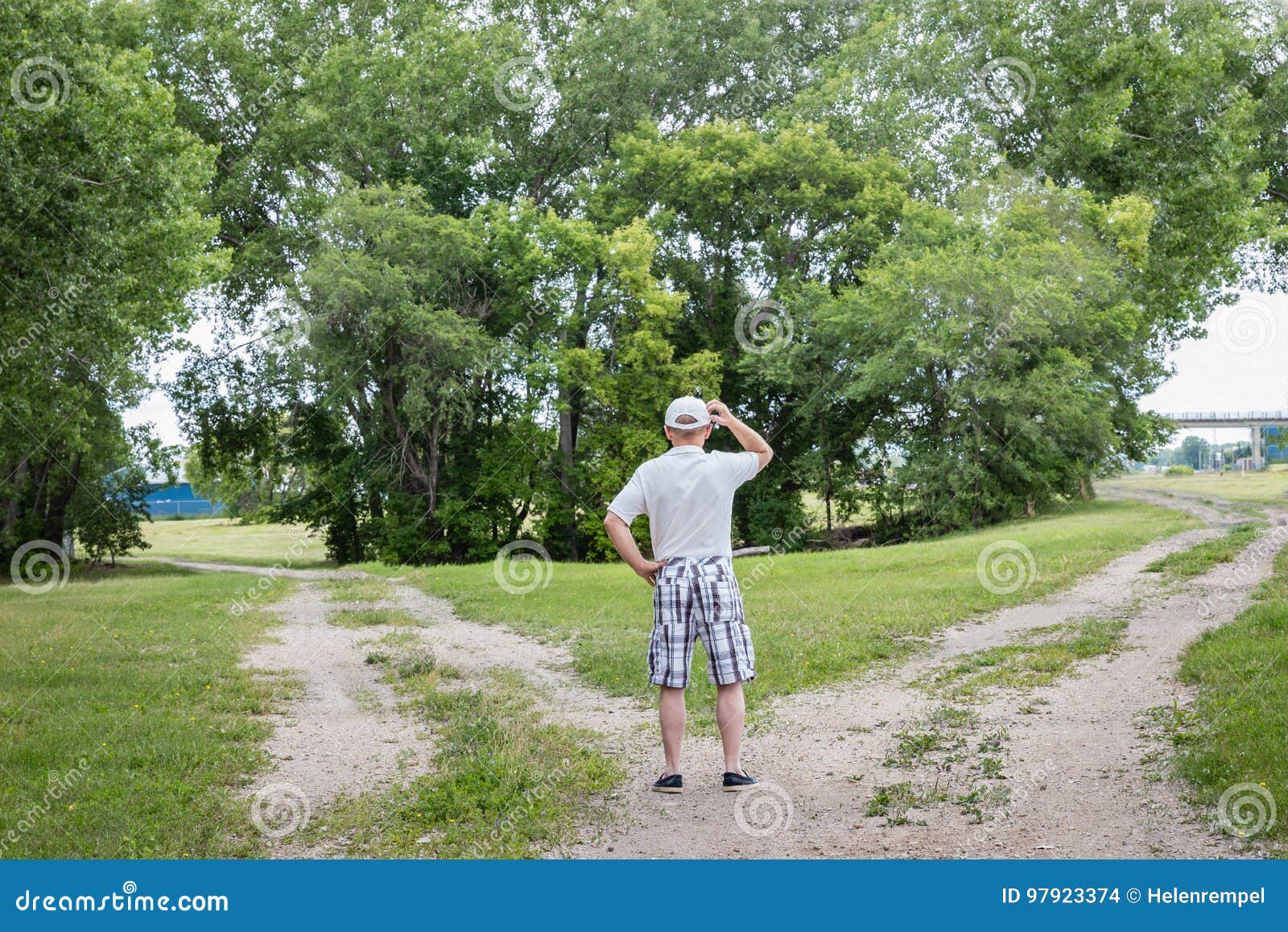 Man Standing at the Fork in the Road Scratching His Head. Stock Photo ...