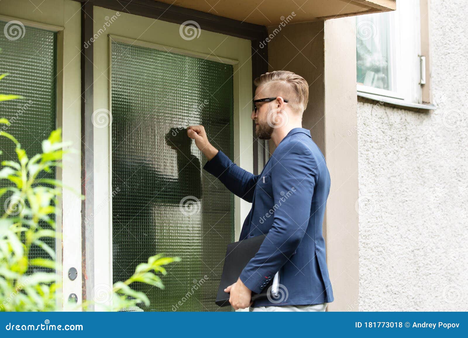 A Man Knocking On A Red Door With A Knocker Royalty-Free Stock Photo ...