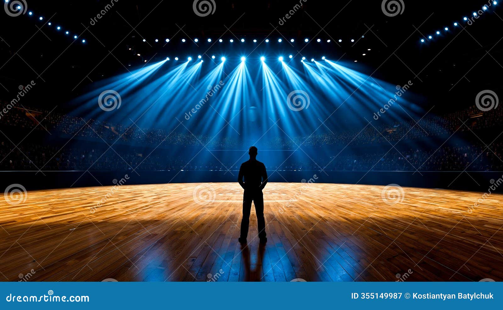 A Man Standing in Front of a Large Arena with Spotlights Stock Image ...