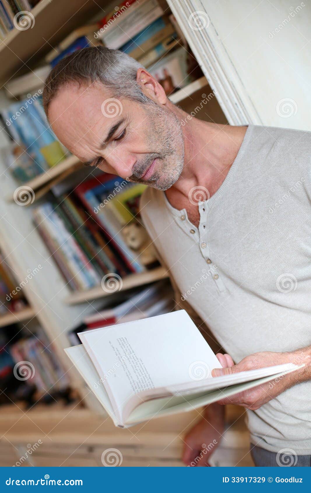 Man Standing in Front of Library with Book in Hands Stock Image - Image ...