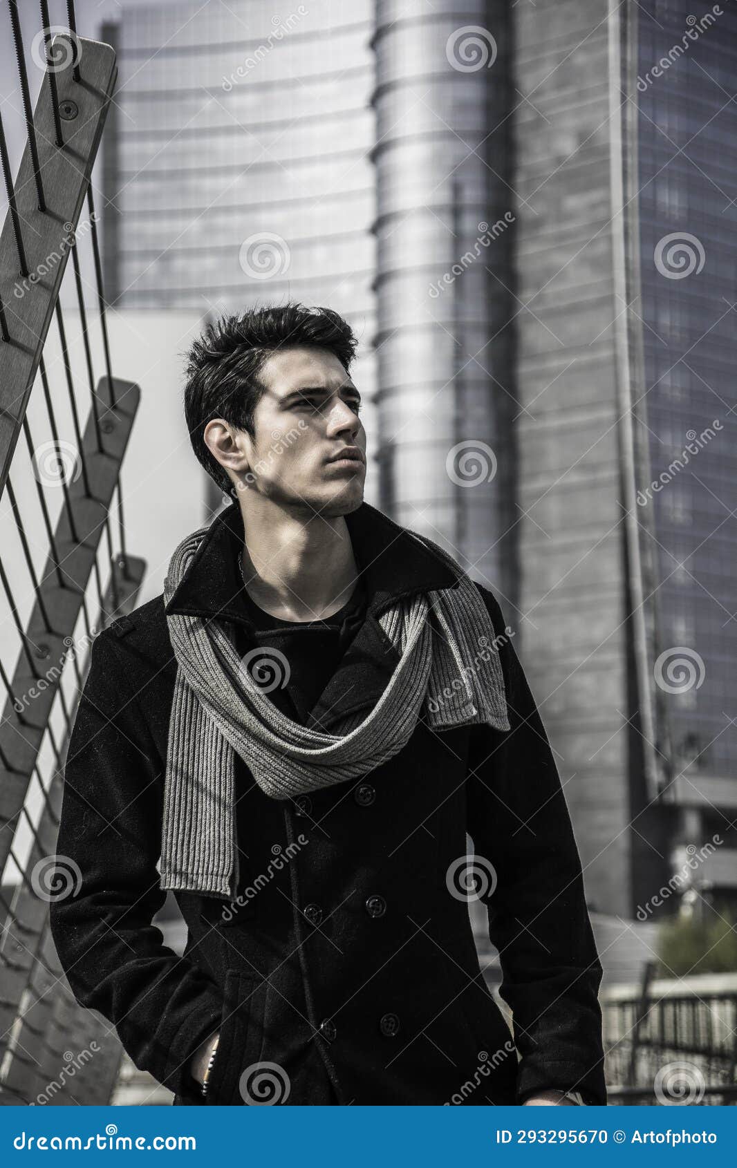 Photo of a Man Standing in Front of a Towering Skyscraper Stock Photo ...