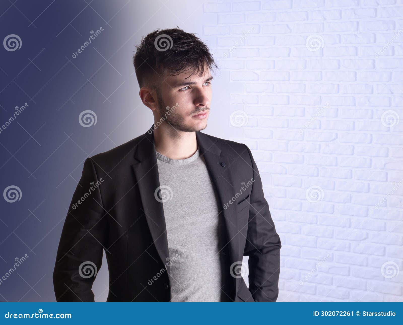 Photo of a Man Posing in Front of a White Brick Wall Stock Image ...