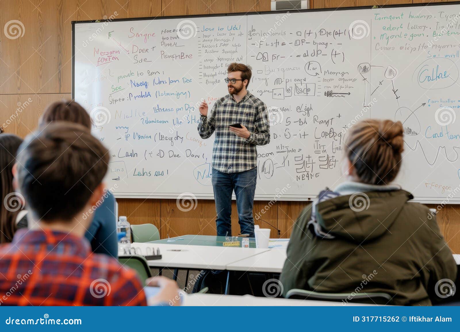 A Man Standing in Front of a Whiteboard, Giving a Lecture in a ...