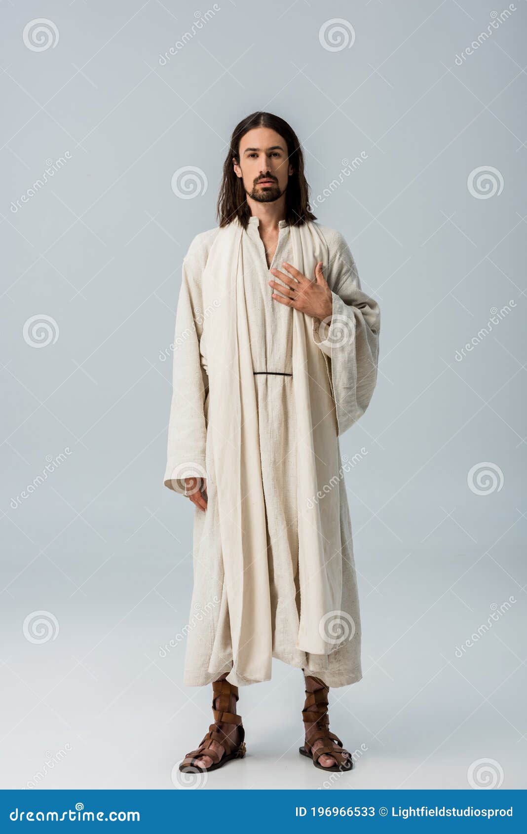 Man Standing with Hand on Chest on Grey Stock Image - Image of ...