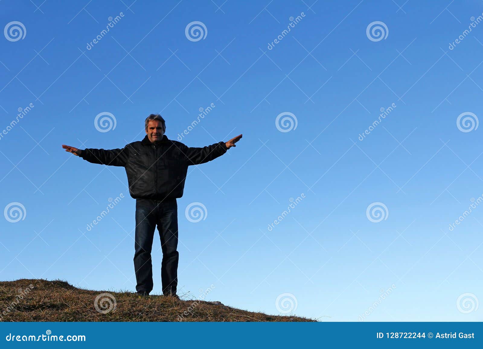 A Man Standing High Up on a Mountain Stock Photo - Image of arrival ...