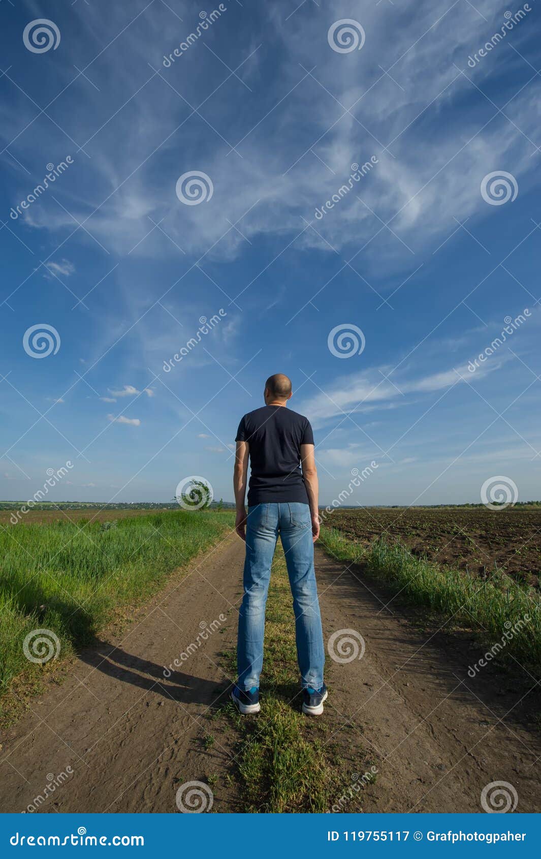 Man is Standing with His Back in the Field and Staring into the Stock ...