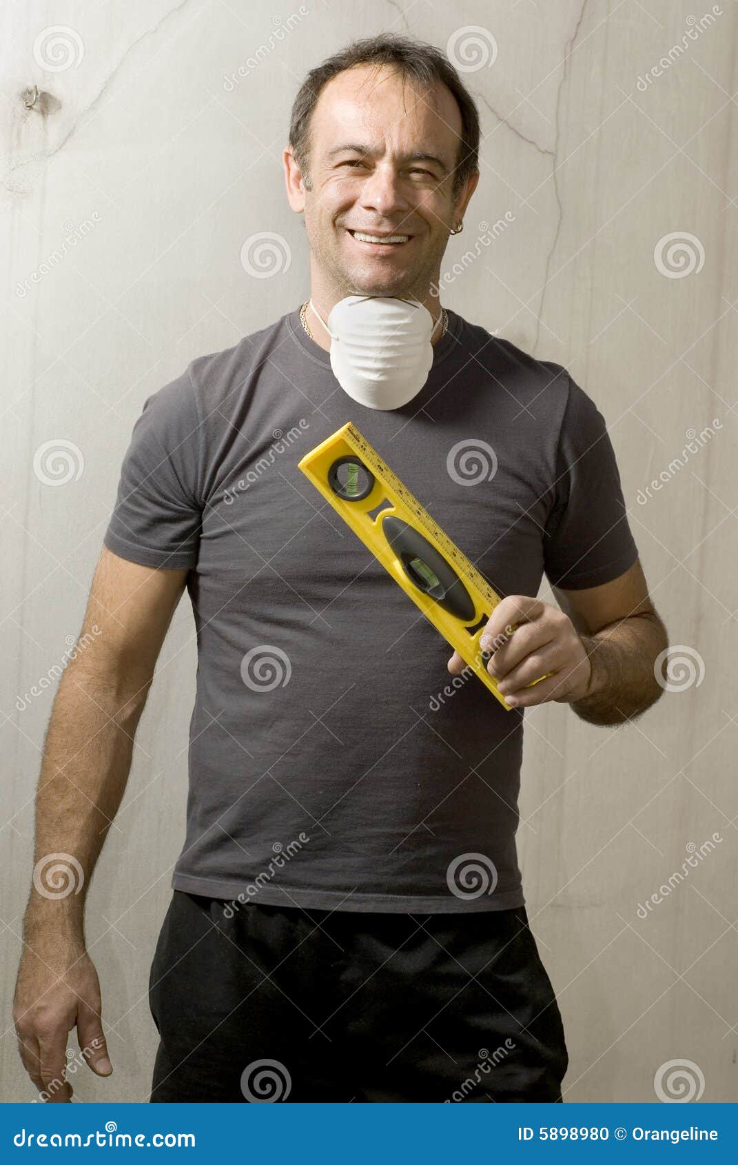 Man Standing Holding Level - Vertical Stock Photo - Image of mask ...