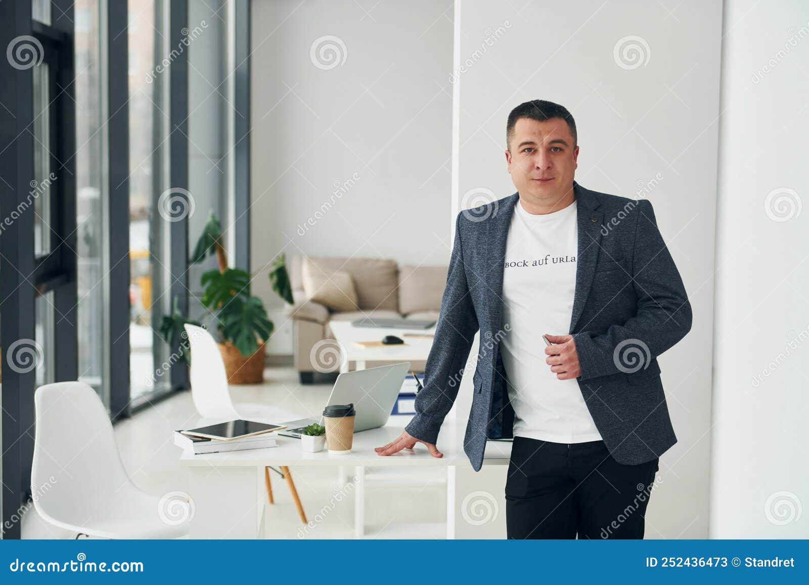 Man Standing Indoors in the Modern Office at Daytime. Conception of ...