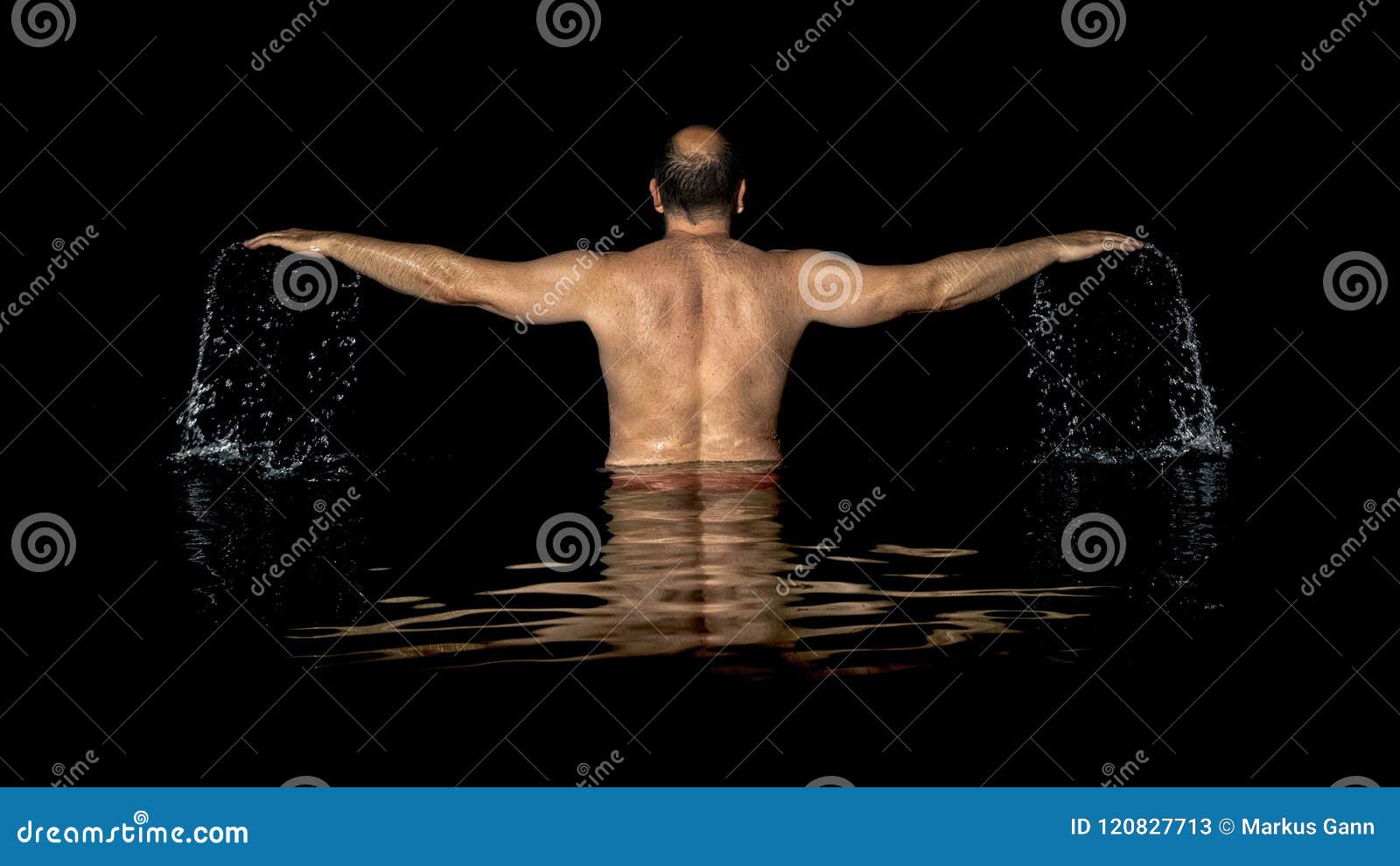 A Man Standing Inside the Water and Spreads His Arms Stock Image ...