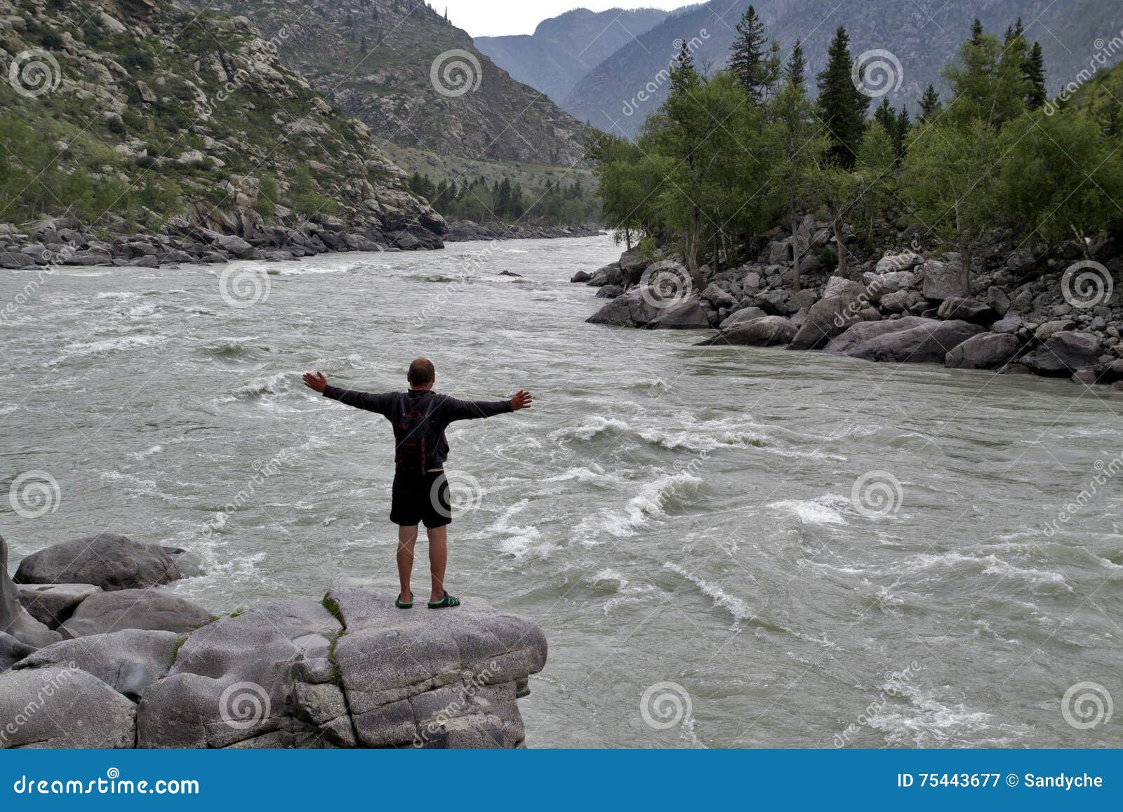 Man Standing on a Large Rock Spread His Arms Over Mountain River Stock ...