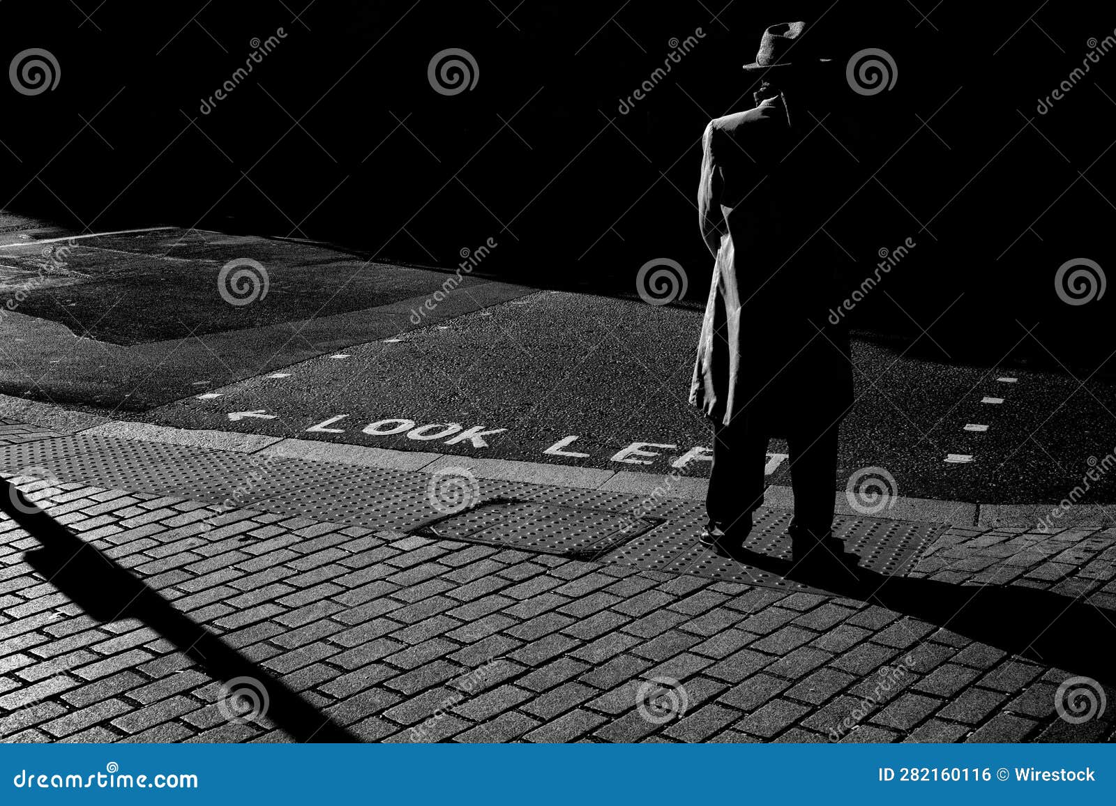 Man Standing in a Lonely Street at Night, Shadows Falling on Street ...